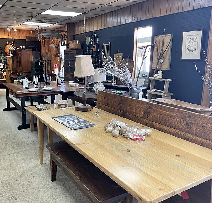 Rustic wooden tables showcase carefully curated home goods against a navy accent wall&mdash;proof that good design never truly goes out of style.