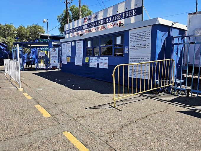 The blue ticket booth stands like a portal to bargain dimension, where children under 3 enter free and adults pay less than a fancy coffee.