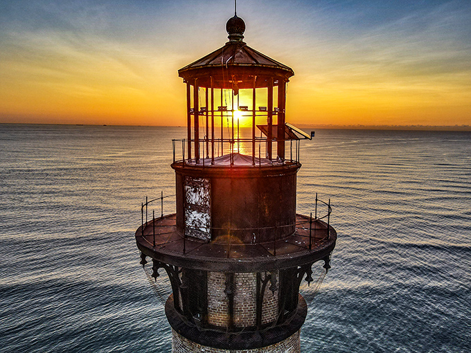 The lighthouse's weathered top still keeps watch, a retired sea captain who can't quite give up scanning the horizon.
