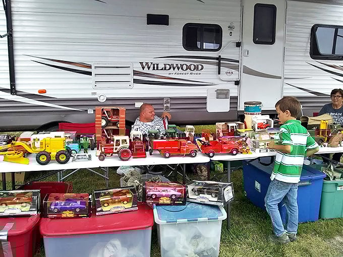 Childhood nostalgia parked in neat rows. This vendor's vintage toy trucks transport grown men back to sandbox adventures faster than a time machine. 