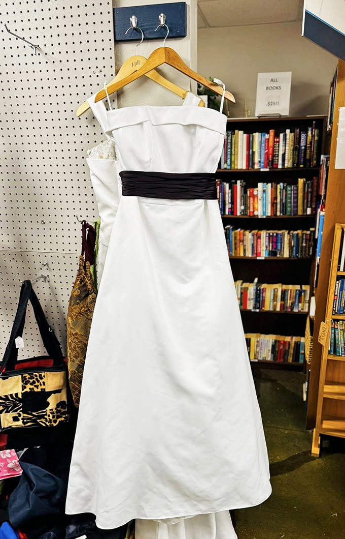 Someone's once-in-a-lifetime gown becomes your unexpected find. This elegant white dress with black sash proves that second chances can be just as beautiful.