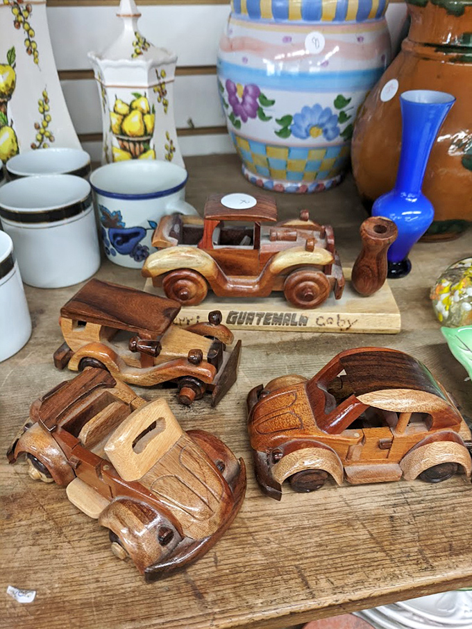 These handcrafted wooden cars from Guatemala aren't just toys—they're tiny works of art that somehow survived the journey to this shelf. Someone's mantel is about to get very happy.