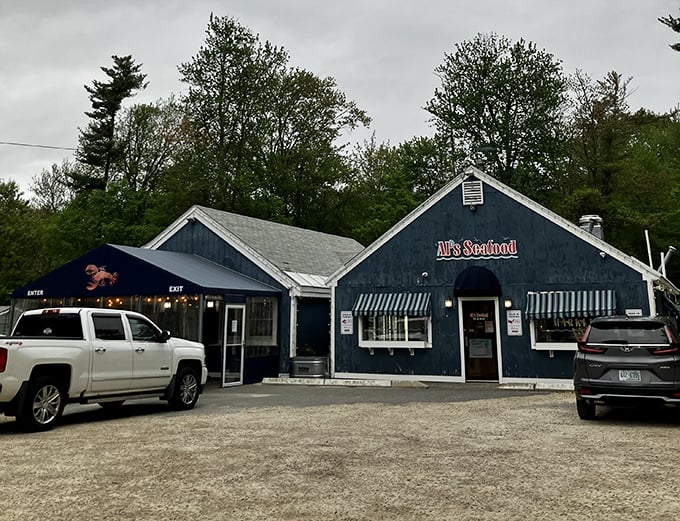 Classic seafood shack vibes &mdash; where the blue exterior and the backdrop of towering trees create a cozy spot that perfectly matches the soul of the food.