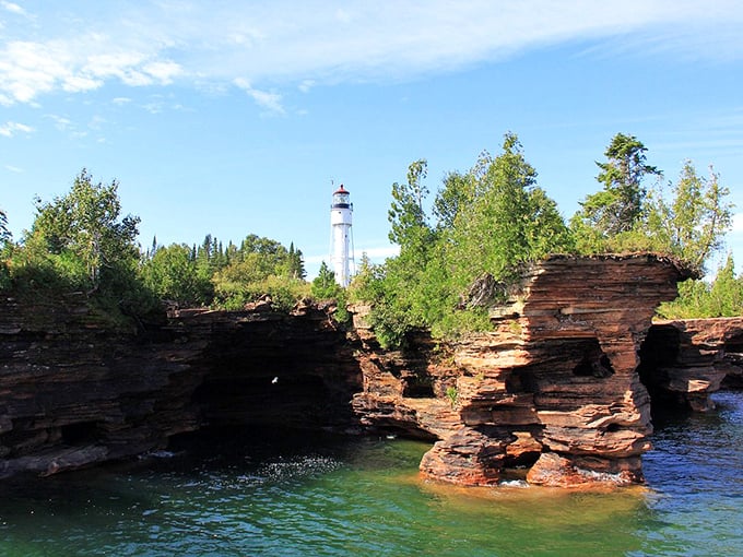 The Apostle Islands rise from Lake Superior like ancient sentinels, their red sandstone cliffs glowing in the sunlight.