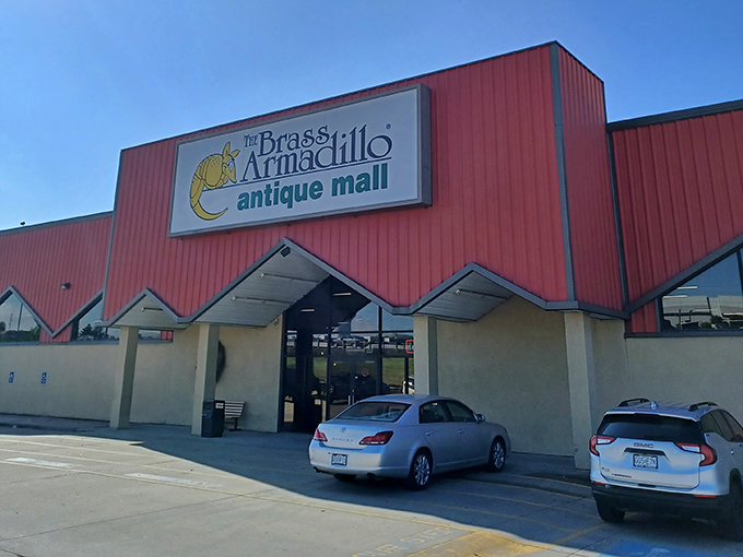 The Brass Armadillo's distinctive red roofline zigzags across the sky, a landmark for those seeking vintage adventures.