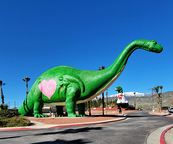 The famous green dinosaur of Cabazon sports a pink heart, proving even prehistoric beasts need love.