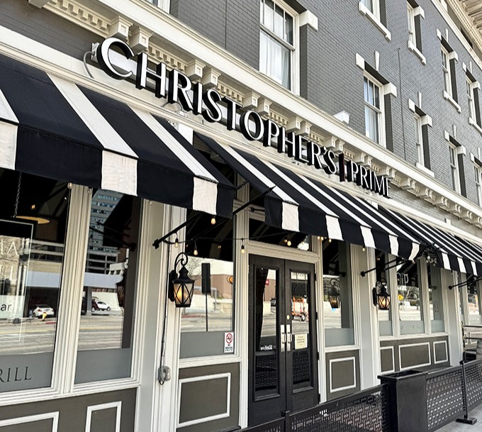 Classic black-and-white awnings signal old-school elegance where prime cuts meet downtown sophistication.