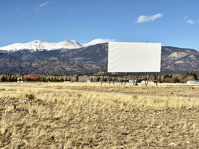 Framed by the snow-capped peaks of Buena Vista, the Comanche Drive-In stands quiet under the afternoon sun, waiting for nightfall to bring its screen to life.