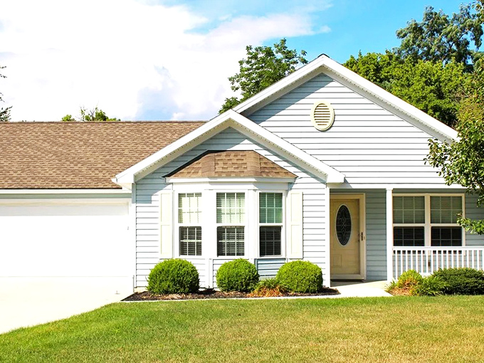 Those perfectly rounded shrubs stand like green sentinels—Country Manor's version of a welcome committee that never asks about your business.