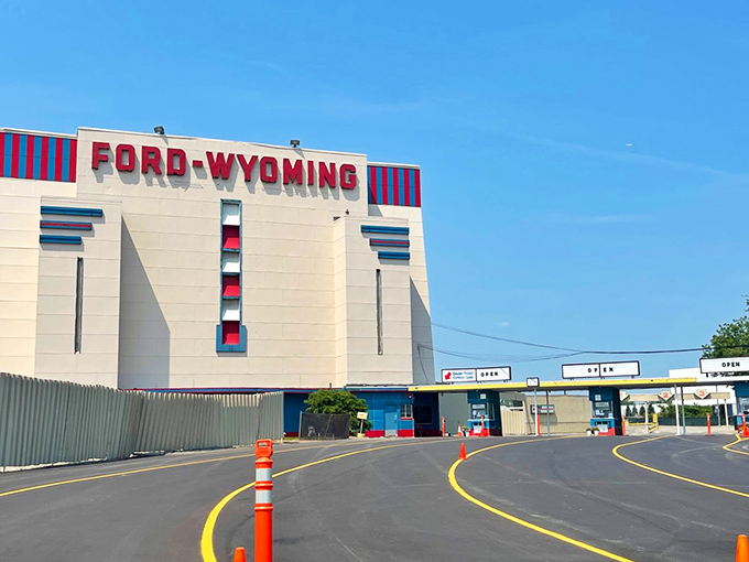 The iconic Ford-Wyoming sign stands tall against the blue sky, a monument to Detroit's enduring love affair with cars and cinema.