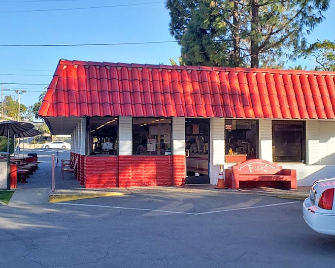 That cheerful red roof signals serious hot dog business - small buildings often hide the biggest flavors inside.
