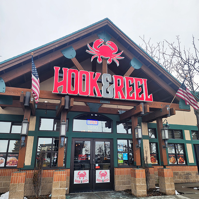 Hook & Reel's bold red crab sign promises a seafood adventure where getting your hands dirty is half the fun.