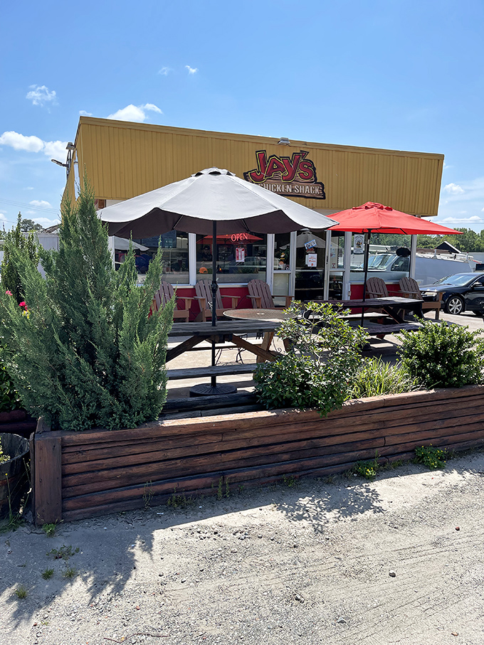 Jay's Chicken Shack's sunny yellow exterior and red umbrellas - like a chicken paradise waiting to happen.