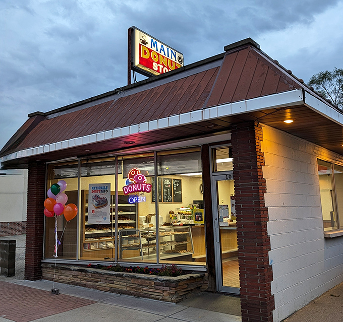 Main Donut Shop glows like a beacon of hope for the sugar-deprived under moody Michigan skies.