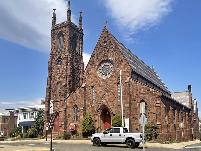 That gorgeous stonework church tower rises like a beacon over streets where your grocery budget breathes easier.