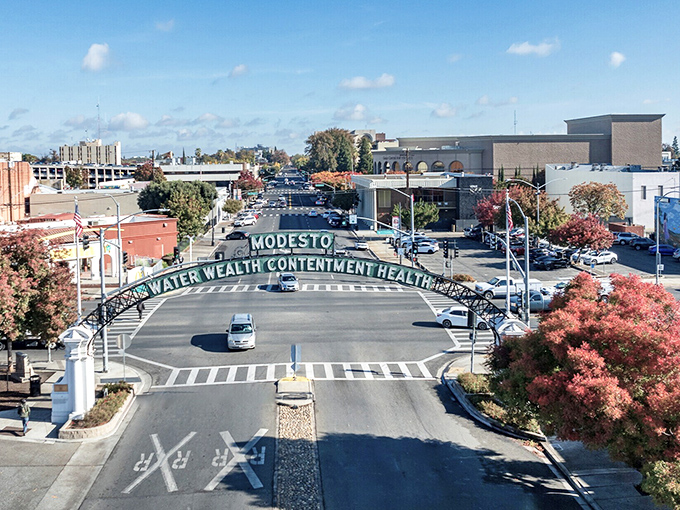The iconic Modesto arch welcomes visitors with promises that retirees treasure: "Water, Wealth, Contentment, Health" - what more could you ask for?