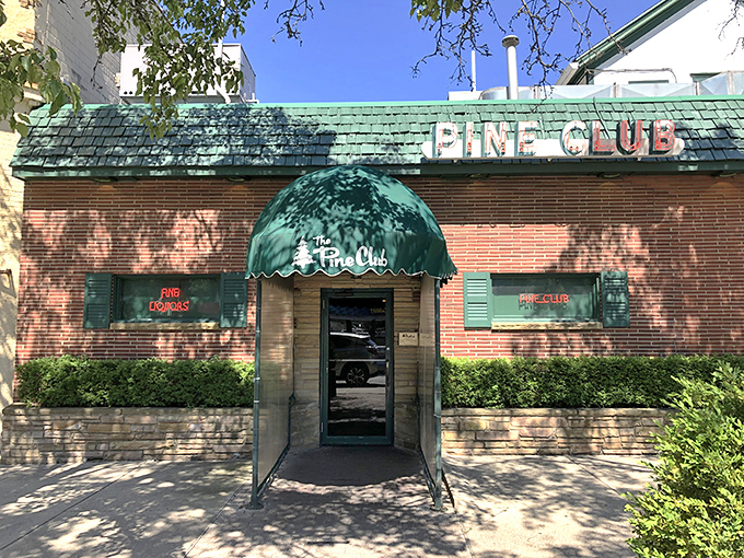 That classic green awning and brick facade whispers decades of perfectly grilled steak stories. 
