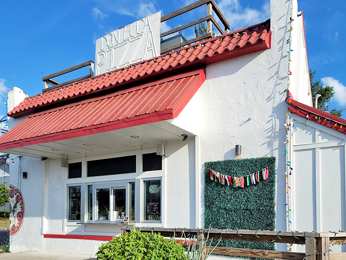 This charming white building with red tiles whispers "authentic Italian" louder than any neon sign ever could.