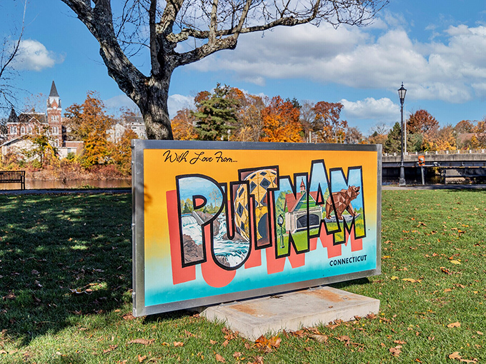 Putnam welcomes visitors with a colorful town sign surrounded by fall foliage, showcasing its small-town New England charm.
