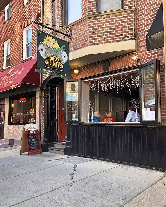 Seafood Unlimited's cheerful storefront promises oceanic adventures just steps from Philadelphia's bustling streets.