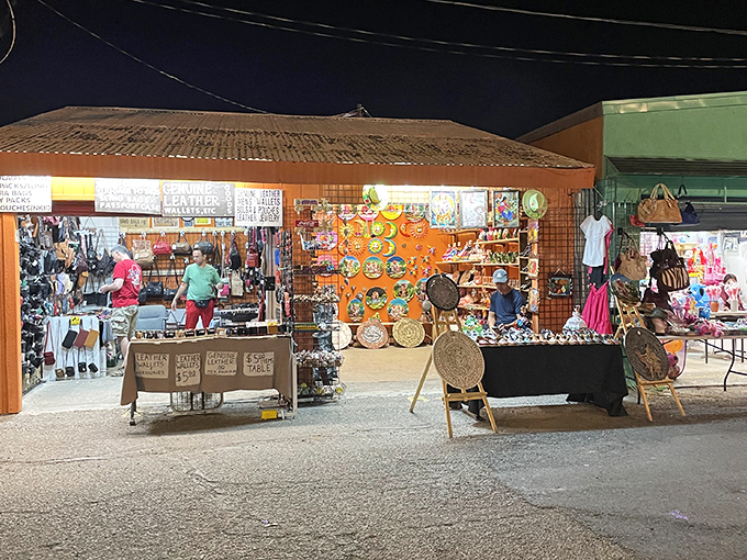 Vibrant colors pop against the evening sky. Tanque Verde's outdoor stalls create a festive marketplace atmosphere as shoppers browse under string lights.