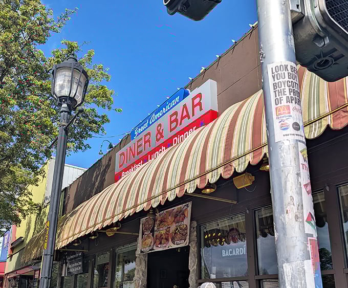 The Great American Diner's striped awning and vibrant signage promise exactly what you'll find inside&mdash;classic comfort done perfectly right.