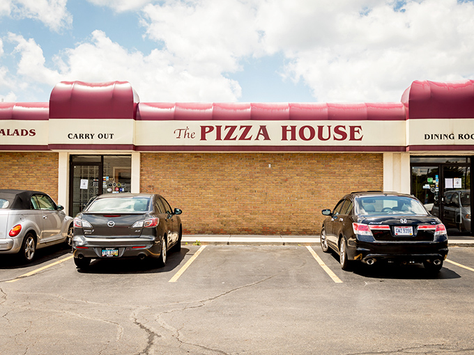 The Pizza House's vibrant red awning stands out like a celebrity on the red carpet - but with better food waiting inside.
