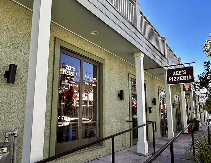 Zee's Pizzeria nestled into its neighborhood spot like it's always belonged there. That sign isn't just advertising&mdash;it's a promise of good things to come.