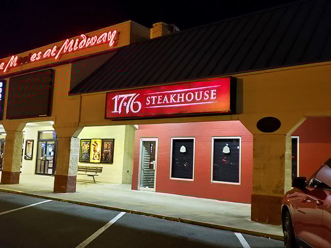 By night, 1776's illuminated sign serves as a beacon for freedom fighters battling hunger with perfectly aged steaks.