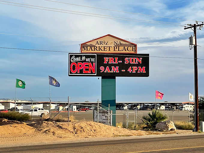Weekend treasure hunting has official hours! The Arizona Market Place sign stands tall against cotton candy clouds, its flags fluttering like excited shoppers' hearts.