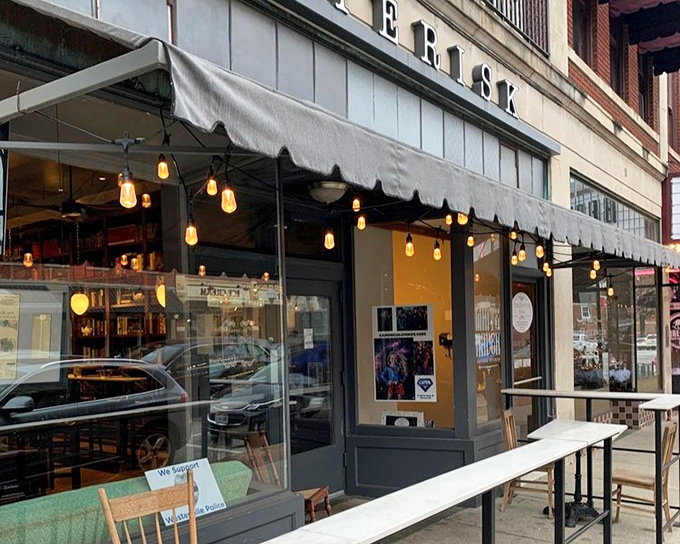 String lights twinkle above Asterisk's sidewalk seating. Urban dining with a touch of starlight magic.