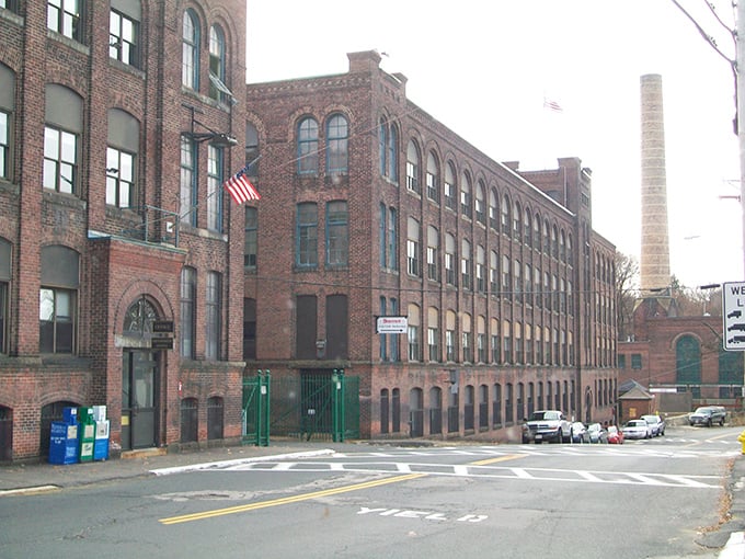 Red brick buildings stand sentinel over a town where your fixed income feels surprisingly flexible.