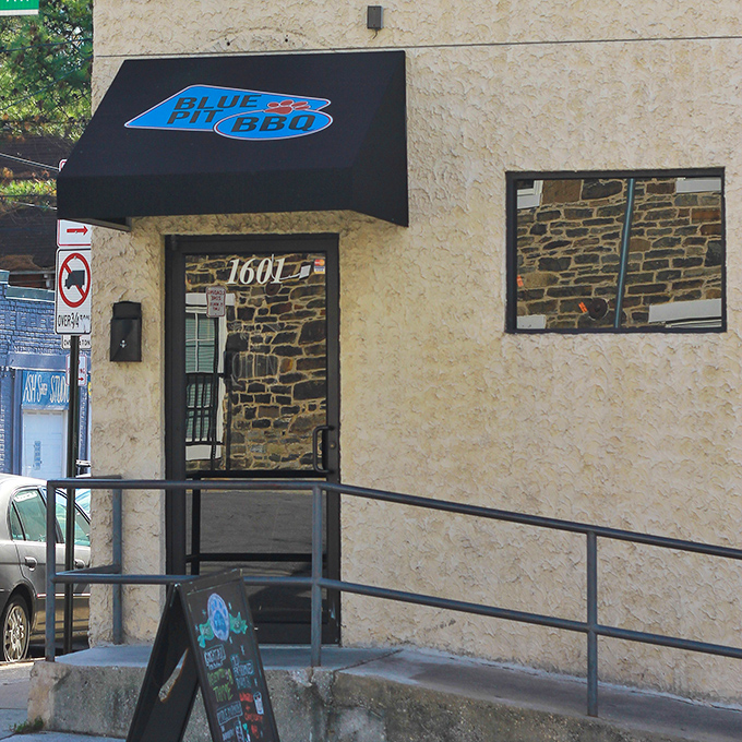 The simple black awning of Blue Pit BBQ offers a humble invitation to some of Baltimore's most impressive smoked meats.