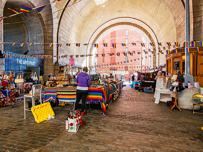 Colorful banners dance overhead as shoppers hunt for treasures at Brooklyn Flea. The cobblestones beneath your feet have stories older than your grandma.