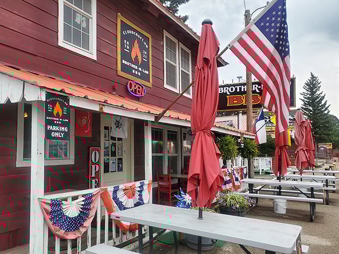 American flags and red umbrellas welcome you to Brother-N-Law, where mountain air meets mesquite smoke in perfect harmony.