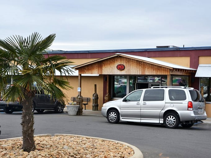 That tropical palm tree and rustic facade hint at coastal flavors waiting just beyond those doors.