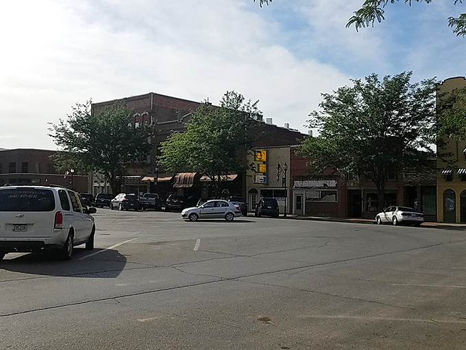 Historic buildings frame streets where shopping means chatting with store owners who remember your name every time.