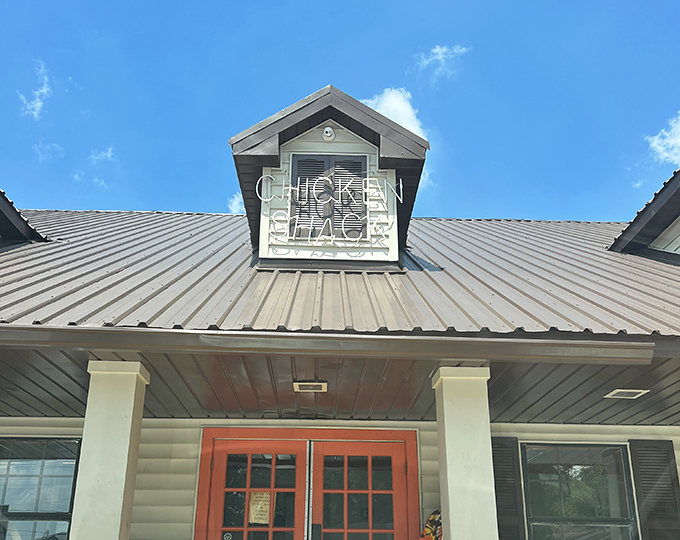 Simple siding, bold stripes, and a sign that promises exactly what you'll get &ndash; no-nonsense chicken that speaks for itself.