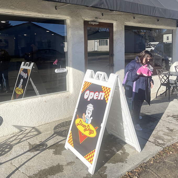 The sunset glow on Diner Dogs' window creates the perfect backdrop for hot dog magic. Simple pleasures in a simple setting.