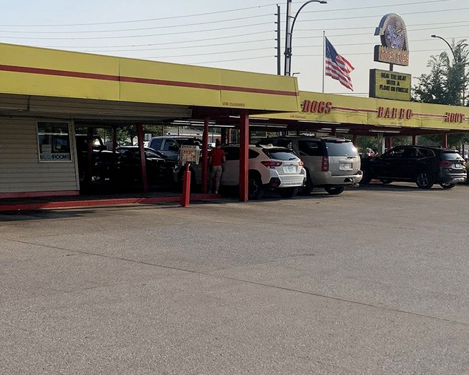 Cars line up at Dog n Suds, where root beer flows and hot dogs sizzle under that classic yellow awning.