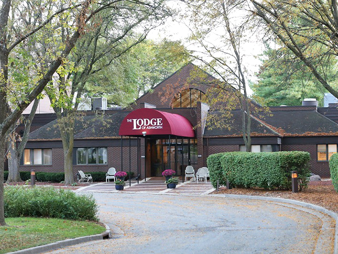 Nestled among mature trees, the Lodge's brick exterior and welcoming entrance create a retreat that feels both sophisticated and cozy.