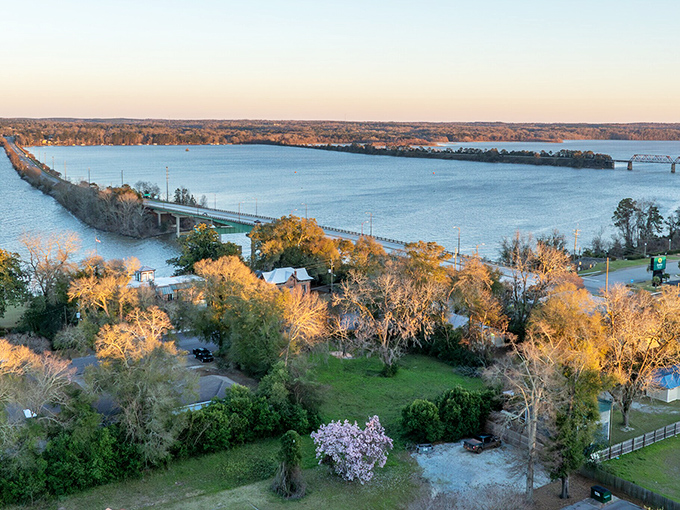 Where sunset meets shoreline in Eufaula: nature's light show illuminates bridges, trees, and possibilities that don't require a second mortgage.