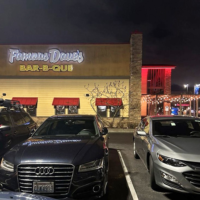 Night falls but Famous Dave's BBQ lights shine bright. The promise of smoky delights draws hungry crowds to this Portland institution.