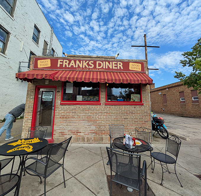 The red awning says "welcome," but the brick exterior whispers "I've got delicious secrets inside."