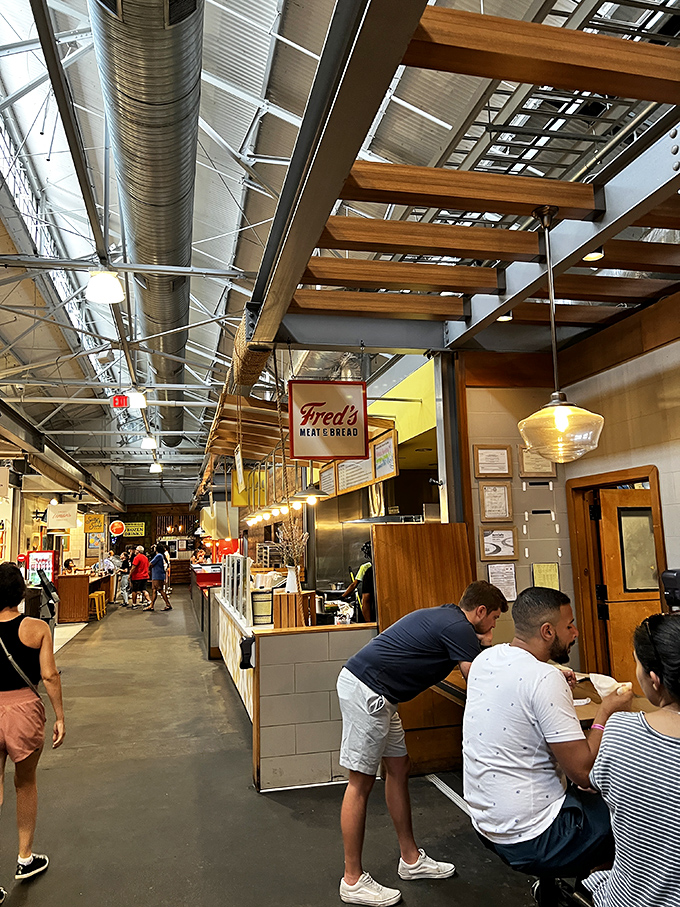Sandwich artistry happens behind that little window at Fred's. The Coca-Cola lineup stands ready to wash down whatever masterpiece you choose.