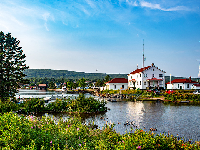 Lighthouse stands guard like a faithful friend, watching over boats and dreams with equal dedication.
