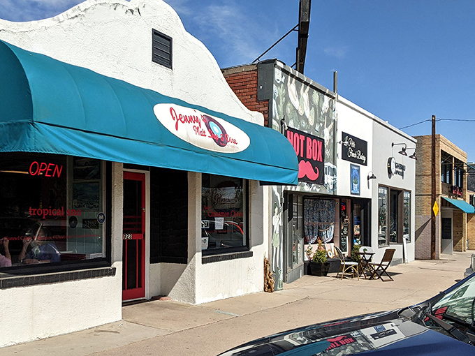 Colorful storefronts create a rainbow of savings where every shopping trip feels like finding buried treasure.