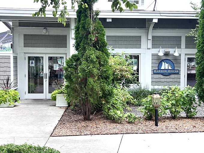 Flanked by elegant greenery, Harbor House's entrance says "Yes, we're fancy, but we'll still let you in wearing boat shoes."