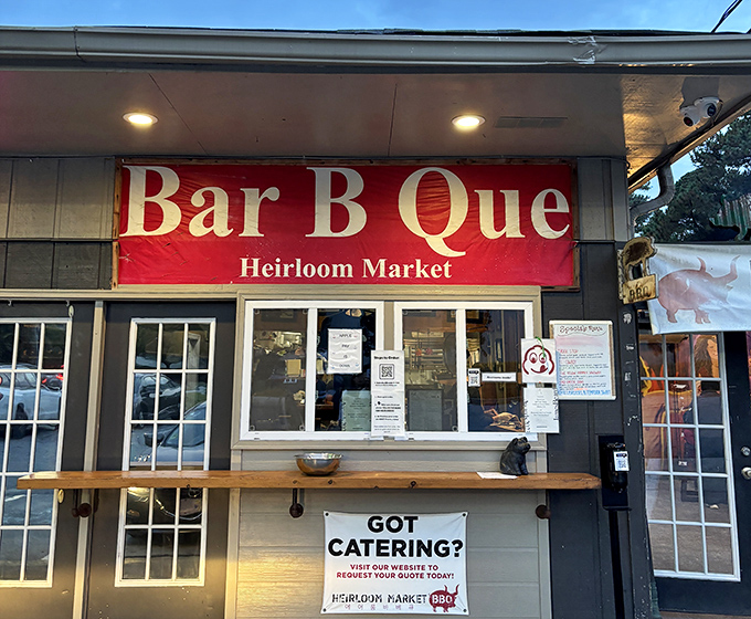That red sign promises the kind of barbecue experience that turns strangers into lifelong customers.