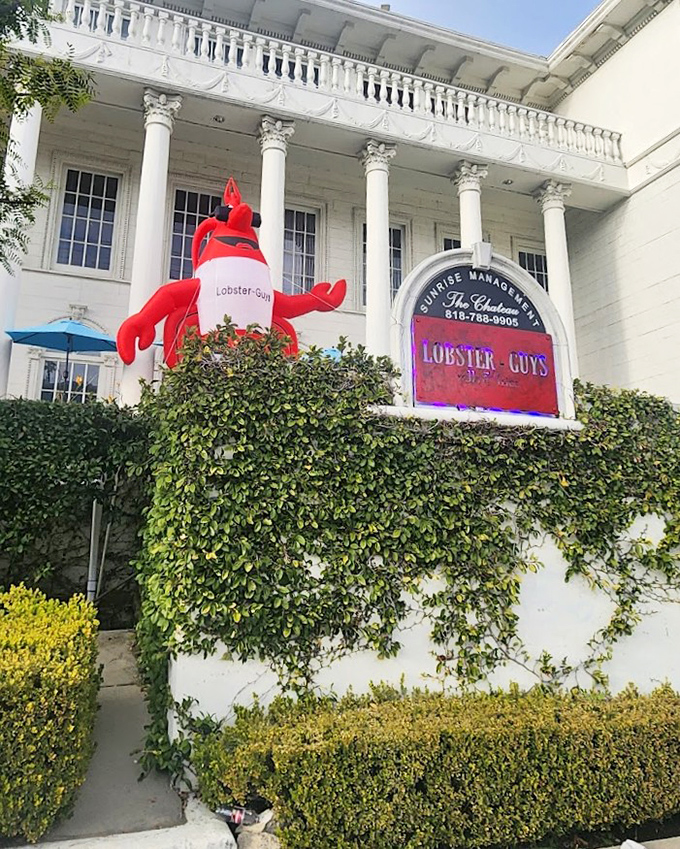 That giant red lobster isn't just decoration - it's a delicious promise of what awaits inside this surprising spot.